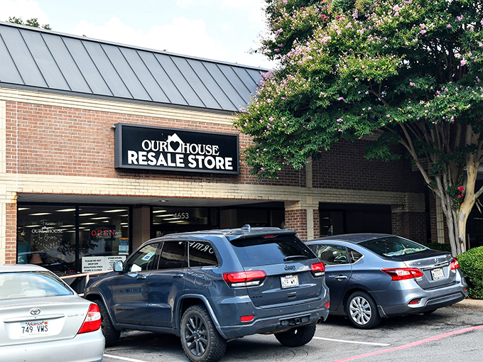 Flowering trees frame Our House Resale Store, where spring bargains bloom year-round for savvy shoppers.