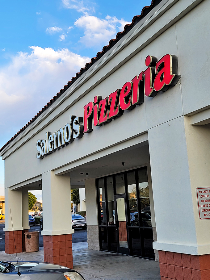 That glowing "Pizzeria" sign cuts through the darkness like a neon promise of delicious things to come.