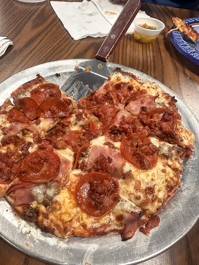 Meat lovers, rejoice! This pizza doesn't just have toppings&mdash;it has a carnivorous congregation of pepperoni, sausage, and ham celebrating atop a thin, crispy crust.