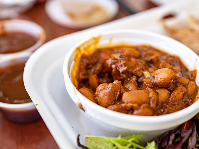 These aren't your average baked beans&mdash;they're smoky, saucy little flavor bombs that have clearly been simmering alongside their meaty brethren for hours.