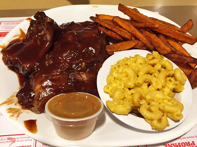BBQ ribs glistening with sauce alongside mac and cheese that's unapologetically yellow. This plate doesn't care about your diet &ndash; it cares about your happiness.