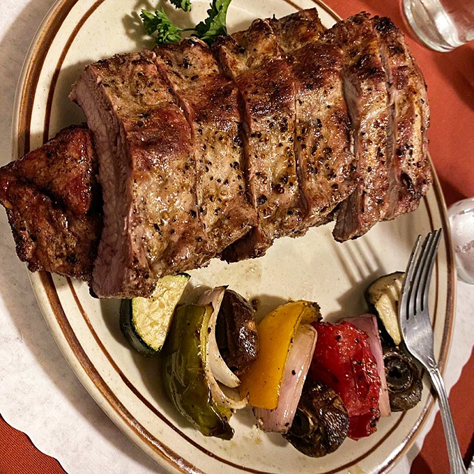 The pork ribs arrive like meaty piano keys, each one perfectly tuned to deliver that harmonious balance of smoke, spice, and tenderness that haunts your dreams.