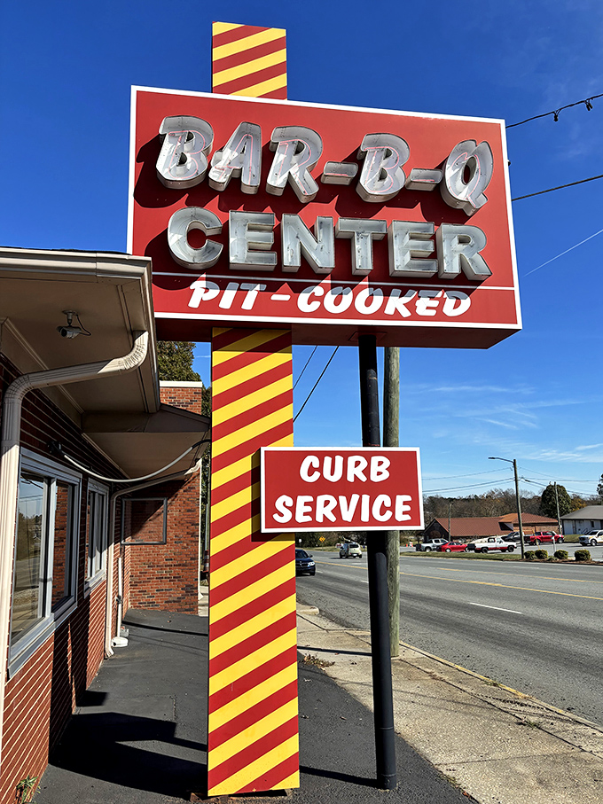The Bar-B-Q Center's iconic sign has guided generations of barbecue pilgrims to smoky salvation, complete with old-school curb service.