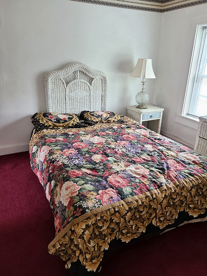 The master bedroom's floral bedspread and wicker headboard create a deceptively peaceful setting. Don't be fooled by the cheerful decor.