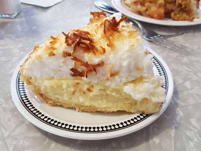 Coconut cream pie with toasted coconut flakes&mdash;like a tropical vacation that doesn't require sunscreen or awkward family photos.