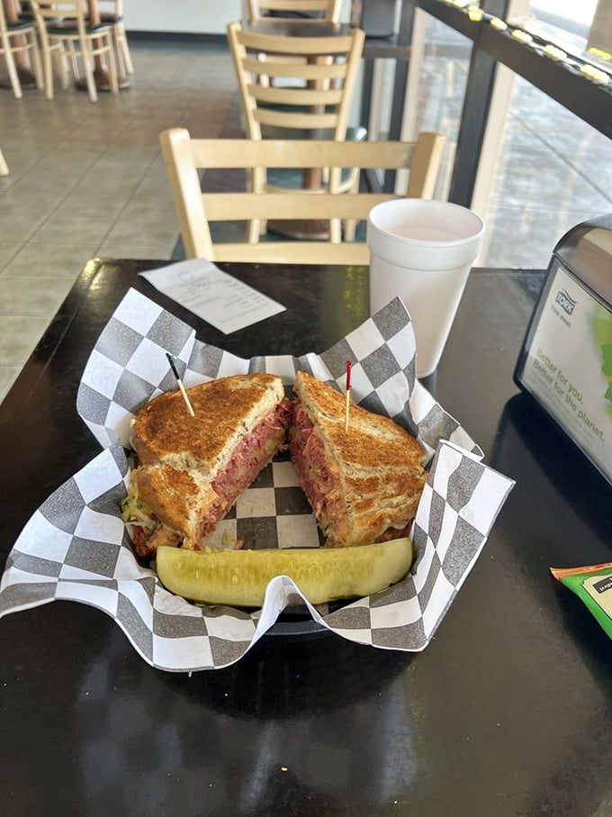 Served with a pickle spear and toothpicks holding it together like tiny structural engineers. This sandwich has more layers than your favorite drama series.