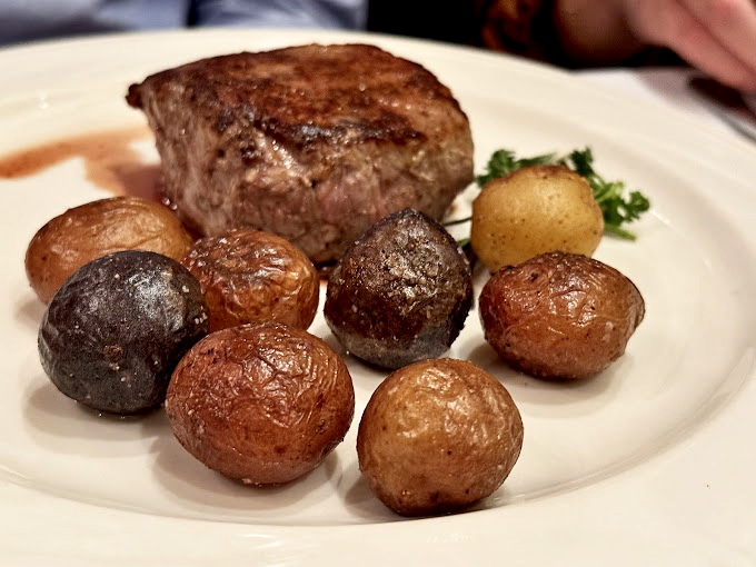 Tiny potatoes with big personalities surround a filet that's cooked with such precision it could teach a master class in temperature control.