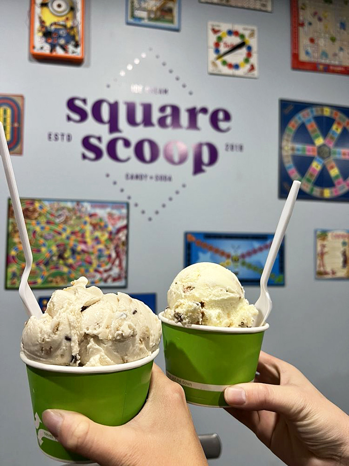 Two scoops, two spoons, infinite happiness. The wall of vintage board games behind suggests you're in for playful flavors.