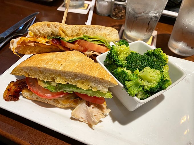 A club sandwich that doesn't mess around&mdash;layers of fresh ingredients stacked between toasted bread with a side of vibrant broccoli that might actually make you eat your vegetables.