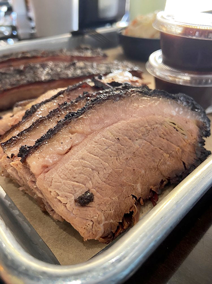 Brisket sliced so perfectly you could read a newspaper through it. That smoke ring isn't just for show &ndash; it's a flavor certificate.