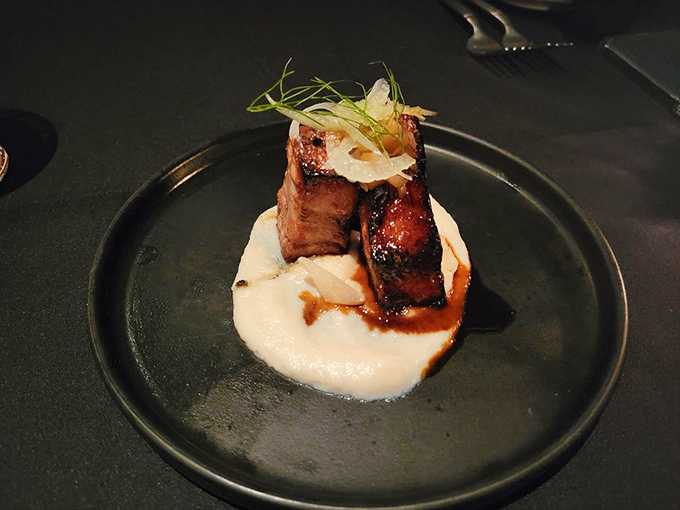 Not your grandma's pork belly. This glistening tower of flavor sits atop a cloud of creamy pur&eacute;e like a meaty monument to indulgence.