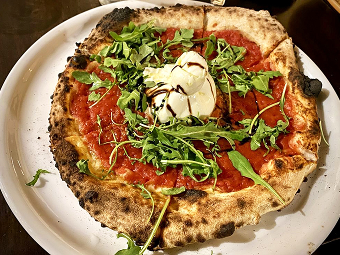 Pizza perfection: that blistered crust, bright tomatoes, and creamy burrata create the holy trinity of Neapolitan pizza bliss. Naples by way of Peoria.