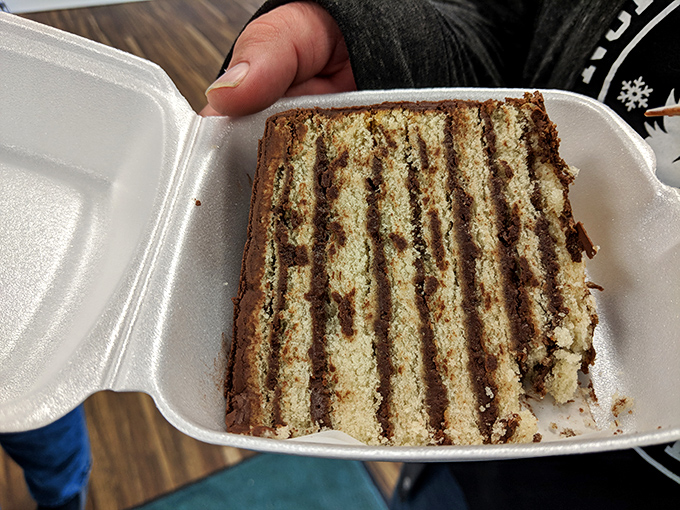A slice of history in a to-go container. Some people collect souvenirs; the wise collect memories measured in layers and frosting.