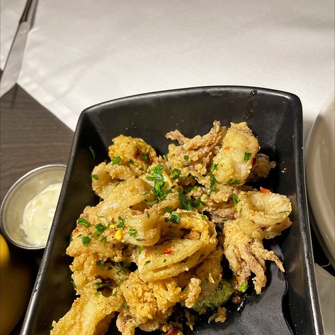Golden, crispy calamari that shatters like delicate glass sculptures when you bite in. The dipping sauce alone deserves its own fan club.
