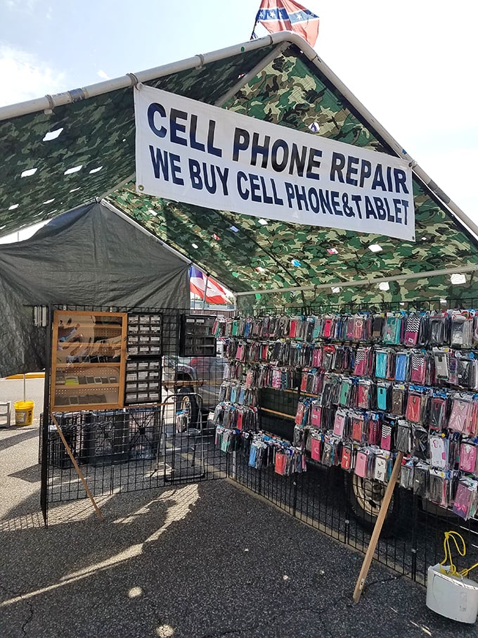 Modern meets vintage as cell phone repair shares space with yesterday's treasures. The camouflage tent suggests your phone might return from repair with survival skills.