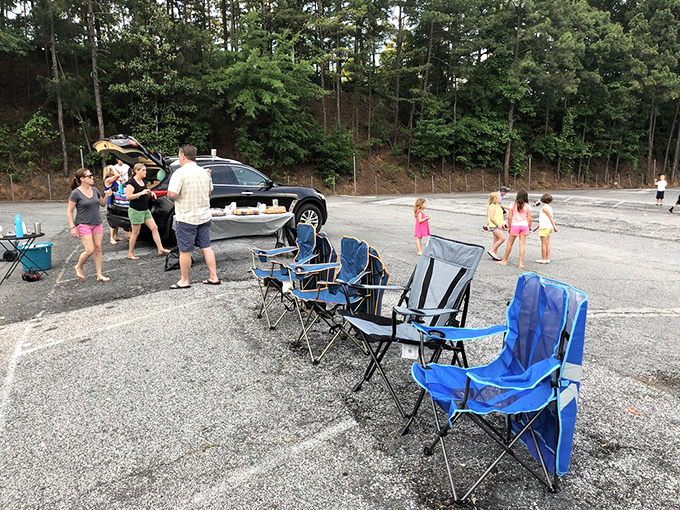 Blue chairs standing at attention, waiting for the sunset show. The drive-in's unofficial living room setup.