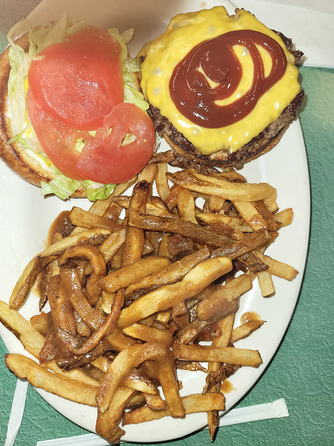 When a cheeseburger comes with fries this golden, you know you've hit the diner jackpot. That swirl of ketchup is practically artwork.