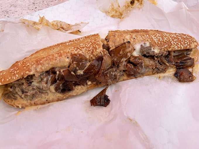 This isn't just a sandwich; it's architecture. Layers of beef, cheese, and onions creating what can only be described as the Taj Mahal of cheesesteaks.