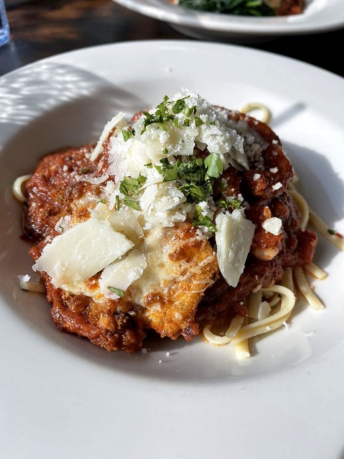 Chicken Parmesan with cheese so perfectly melted, it's doing that stretch thing that haunts your dreams in the best possible way.