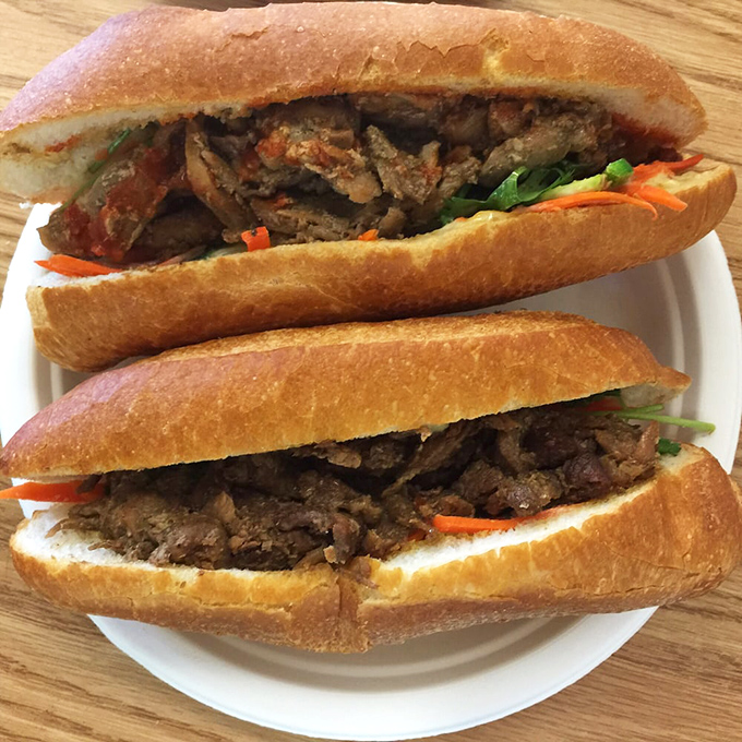 Two banh mi sandwiches sitting pretty on a plate&mdash;like the Lennon and McCartney of lunch, they're even better together than solo.