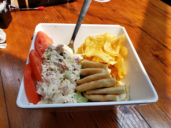 Chicken salad elevated to art form, partnered with fresh tomato wedges and crisp crackers that respect the main attraction without upstaging it.