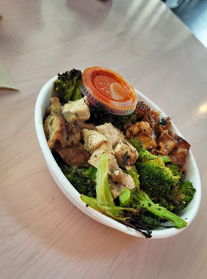 Herb-grilled chicken and roasted broccoli sharing a bowl like old friends at a reunion&mdash;simple ingredients transformed through perfect execution.