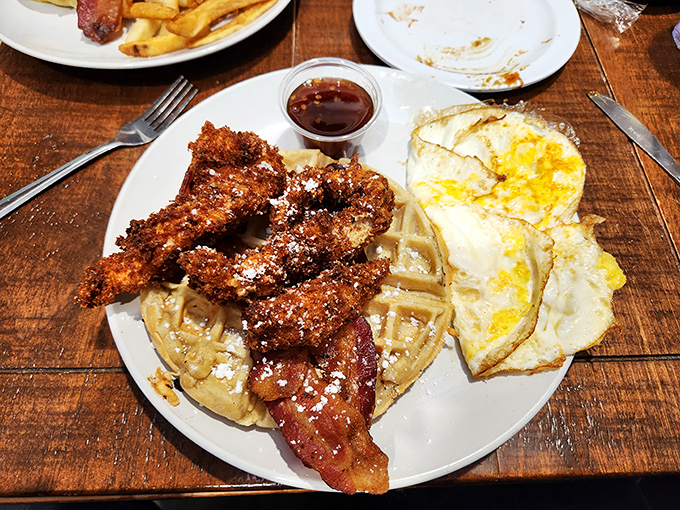 The breakfast equivalent of a standing ovation: golden waffles supporting crispy chicken with eggs playing the delicious supporting role. 