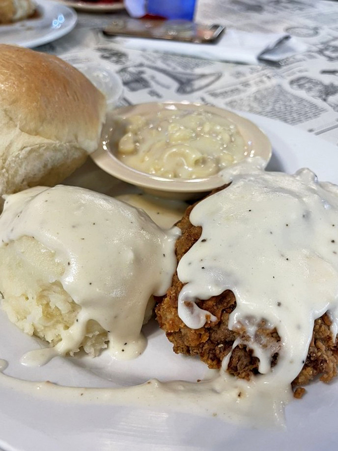 Chicken fried steak smothered in peppery country gravy with a side of mashed potatoes &ndash; comfort food that hugs your insides like a warm blanket.