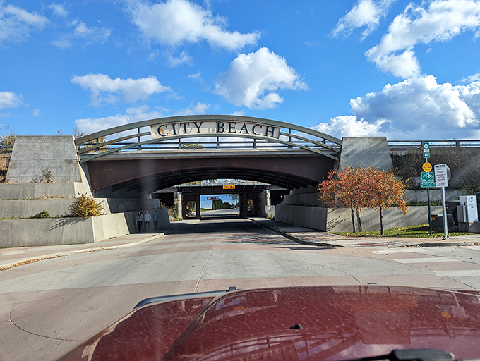 The City Beach entrance welcomes visitors like an old friend, promising sandy shores and mountain vistas just beyond the underpass.