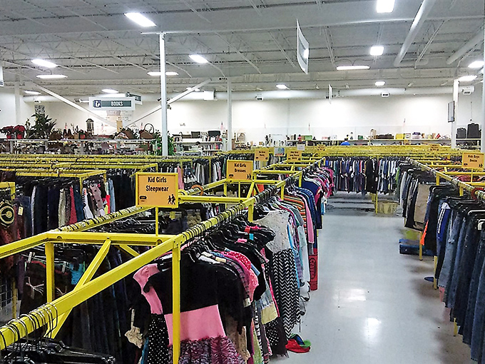 Yellow rails create a roadmap through the clothing wilderness. Each hanger holds a story, a style, and possibly your next favorite outfit.