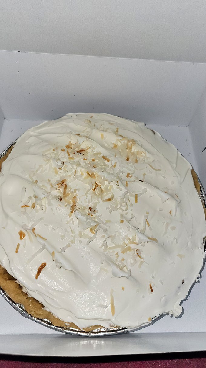 Coconut cream pie with that perfect ratio of fluff-to-substance&mdash;the kind that makes you consider ordering a second slice before finishing the first.