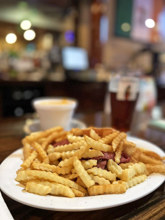 Corned beef hiding beneath a golden avalanche of fries and cheese&mdash;like an Irish-American treasure hunt where everyone wins, especially your taste buds.