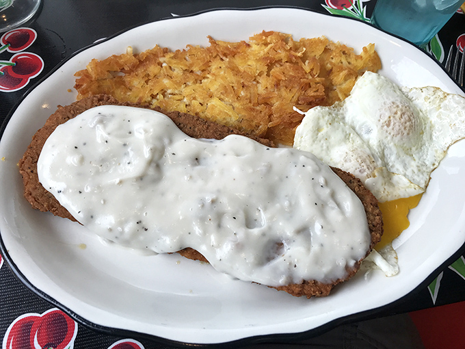 The holy trinity of diner perfection: crispy-on-the-outside, tender-on-the-inside country fried steak, eggs with sunset-yellow yolks, and hashbrowns that actually taste like potatoes. P