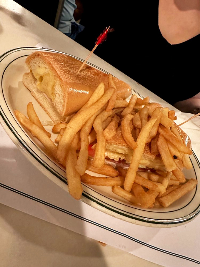 The Cuban sandwich arrives with a golden mountain of fries, a combination so perfect it should have its own national holiday.