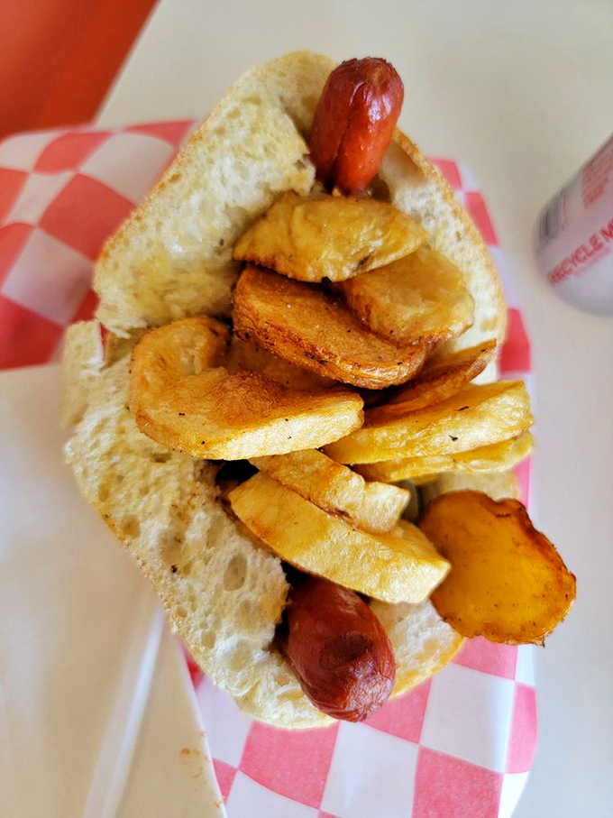 Potatoes and dogs in perfect harmony, like Sinatra and a good microphone. This double trouble demands both hands and a serious appetite.