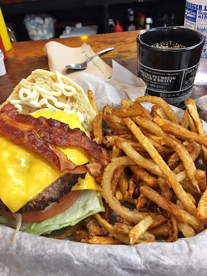 When your burger needs its own zip code. This double-decker masterpiece with golden fries is why elastic waistbands were invented.