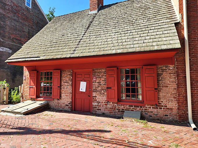 This little brick house with its vibrant red shutters has survived longer than most Hollywood marriages. Colonial minimalism at its most charming.
