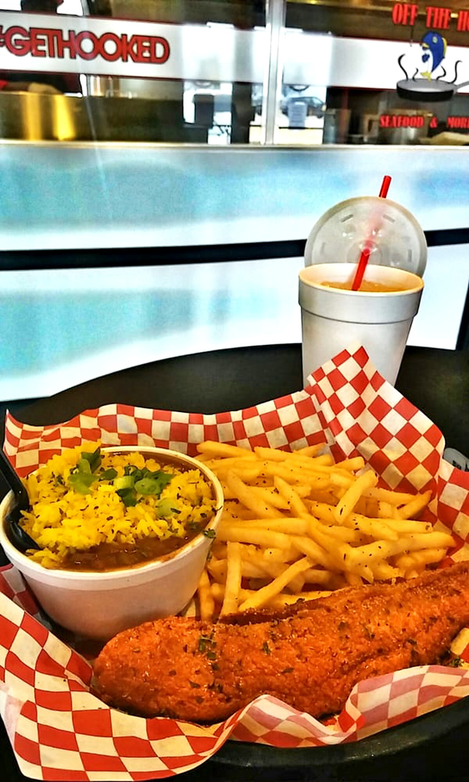 Golden-battered fish resting beside perfectly crisp fries and what looks like rice-topped beans. A coastal classic that found its Oklahoma home.