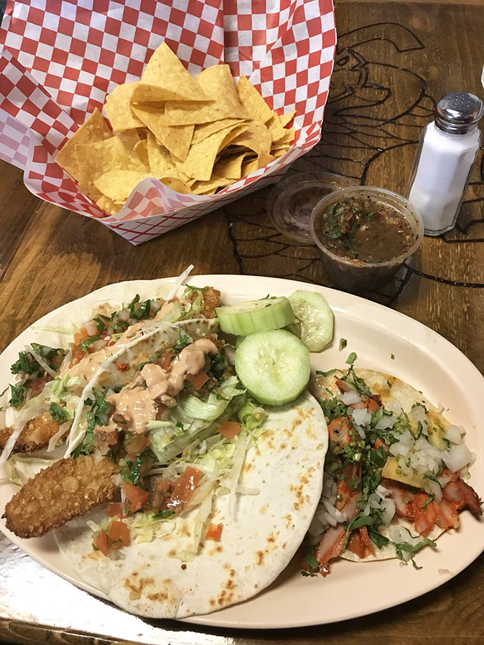 A plate that settles the eternal debate: "Why choose between fish and pork tacos when life is short and both are extraordinary?"