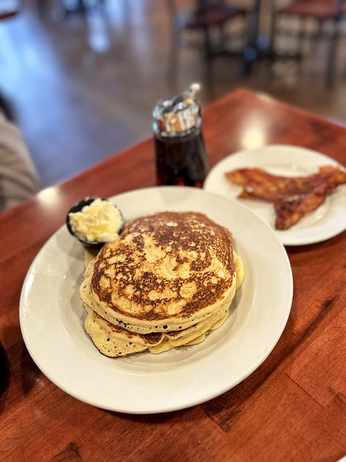 Pancakes so fluffy they need their own ZIP code, with bacon that's achieved that perfect crisp-but-not-shattered texture we all dream about. 