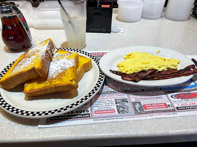 Thick-cut French toast dusted with powdered sugar sits alongside eggs and bacon – the breakfast equivalent of a perfect harmony in three-part harmony.