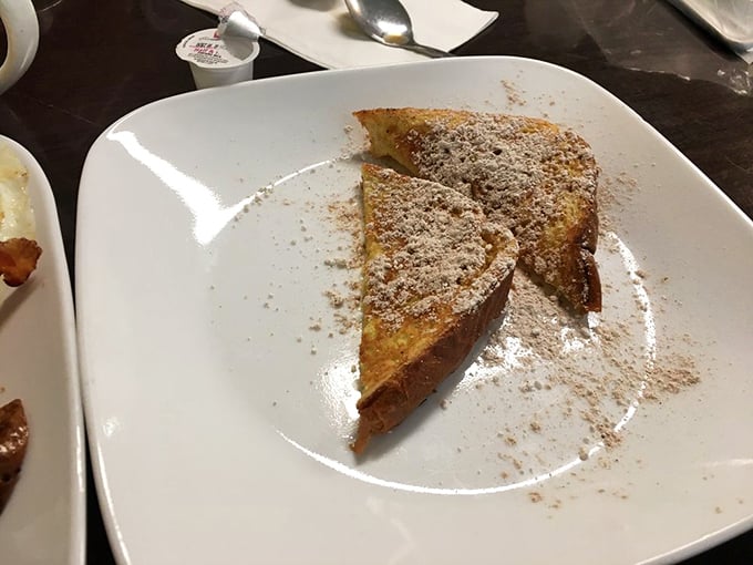 French toast that's achieved that golden-brown perfection we all aim for but rarely accomplish at home, dusted with powdered sugar like fresh snow.