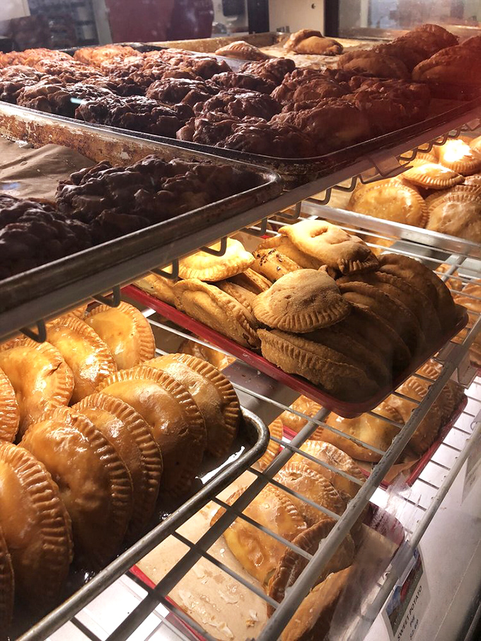 The fried pie assembly line of dreams. Rows of golden-brown pastry pockets filled with seasonal goodness await their forever homes in lucky stomachs.