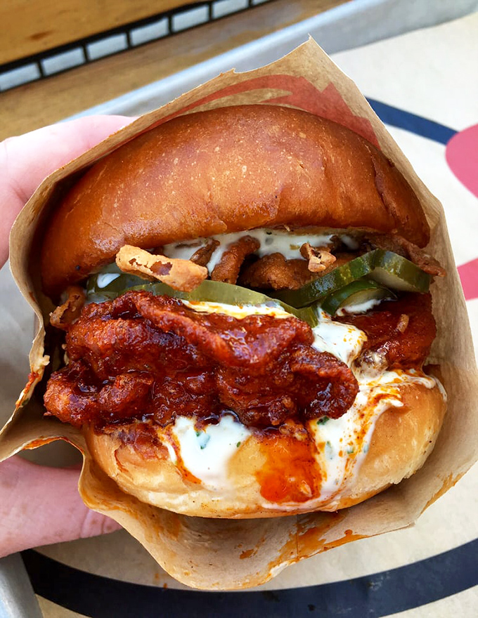 This isn't just a sandwich&mdash;it's an architectural masterpiece of crispy chicken, melty cheese, and sauces that would make even a food photographer weep with joy.