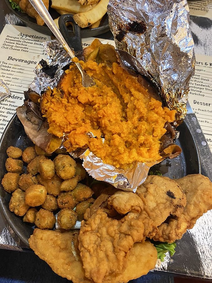Southern comfort on a plate: golden fried chicken tenders, crispy okra, and sweet potato that could make your grandmother question her own recipe.