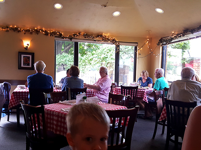Red checkered tablecloths &ndash; the universal signal for "good, honest food served here." These diners know they've found their happy place.