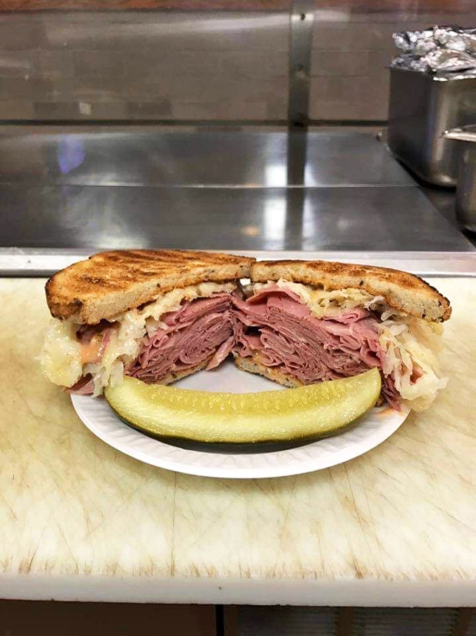 Cross-section of greatness: This Reuben reveals its architectural brilliance. The meat-to-sauerkraut ratio would make Einstein proud of its perfect equation.