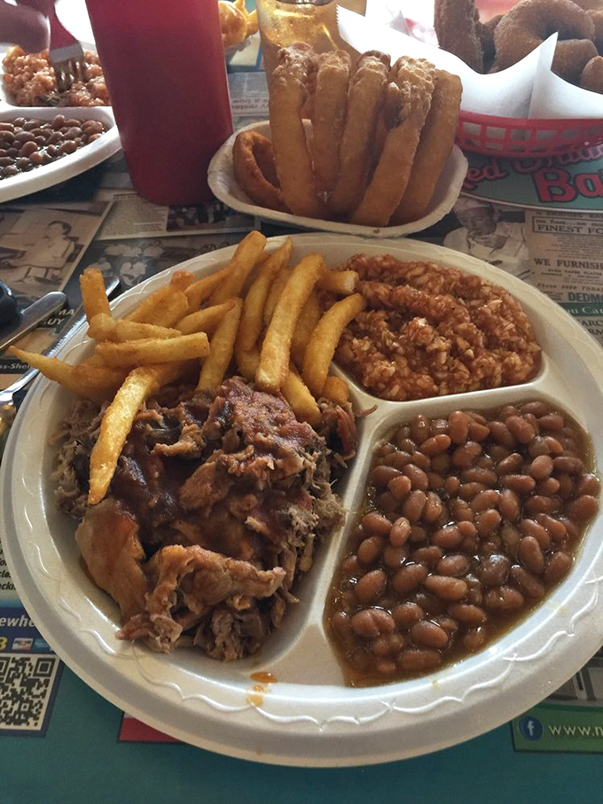 The barbecue plate in all its glory&mdash;meat, beans, slaw, and fries arranged like edible artwork on a canvas of simple white dishware.