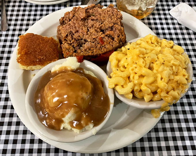 A plate that balances all food groups: meatloaf, mac and cheese, gravy-soaked mashed potatoes, and cornbread for essential carb fortification.