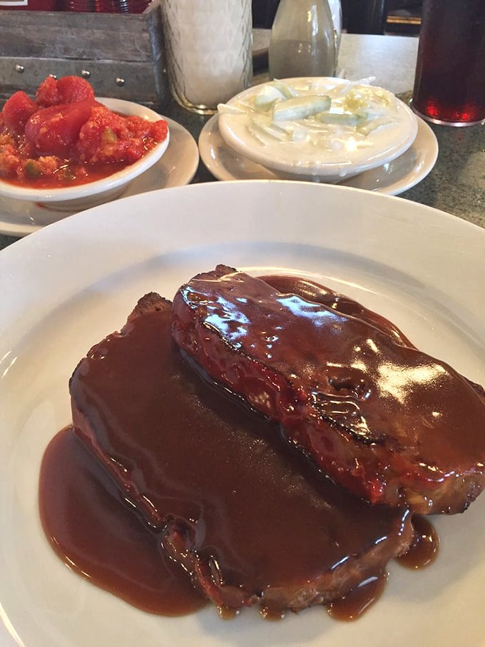 Meatloaf so tender it barely needs the knife. Served with stewed tomatoes and mashed potatoes, it's the holy trinity of comfort food.